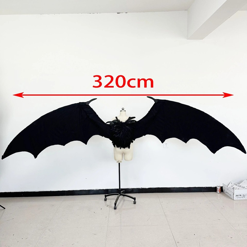 Black motorized retractable bat-shaped mechanical wings fashion show ...