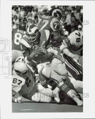 Press Photo #24 Rams' Eddie Hill runs over #67 Cardinals' Bill Acker ...