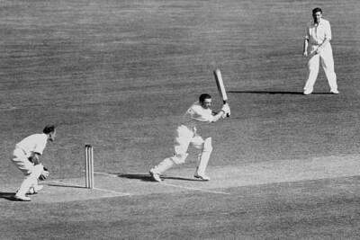 Cricket Queensland's Don Tallon drives a single, watched by Englan- Old ...