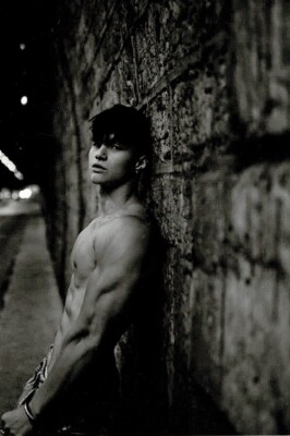 Shirtless muscular man cruising leaning against a wall gay man's ...