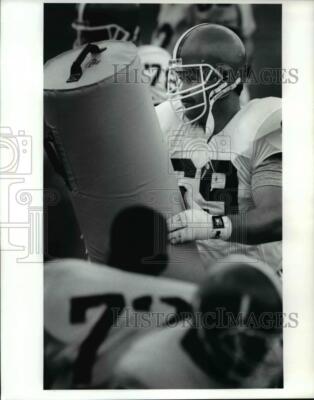 1990 Press Photo Dan Fike retrieves a tackling dummy during drills ...