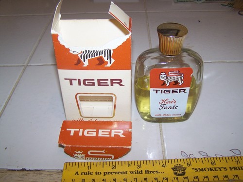 Vintage Tiger Hair Tonic with box about half full bottle. box is tore ...