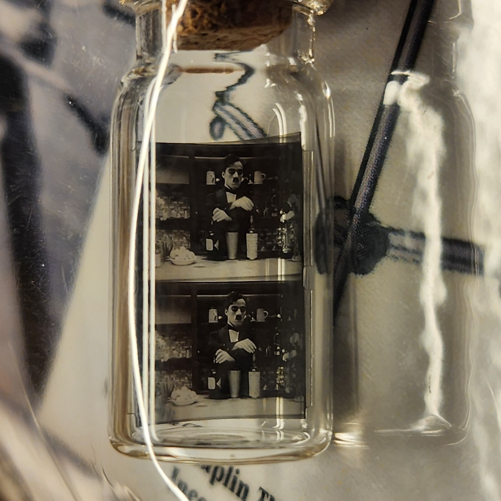charlie chaplin vintage film cells . strip inside vial , photo montage ...