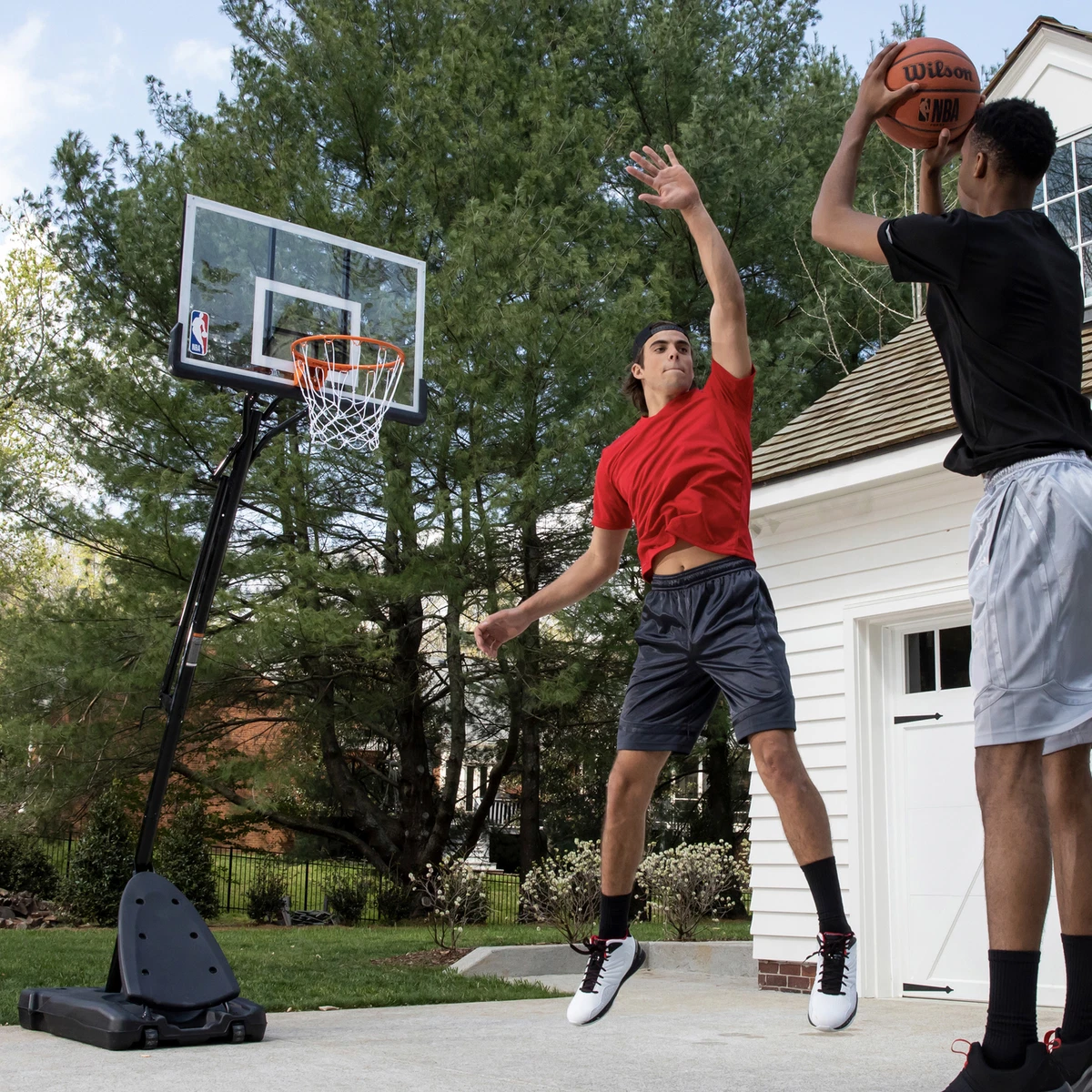Kids Playing Basketball Outside In Driveway