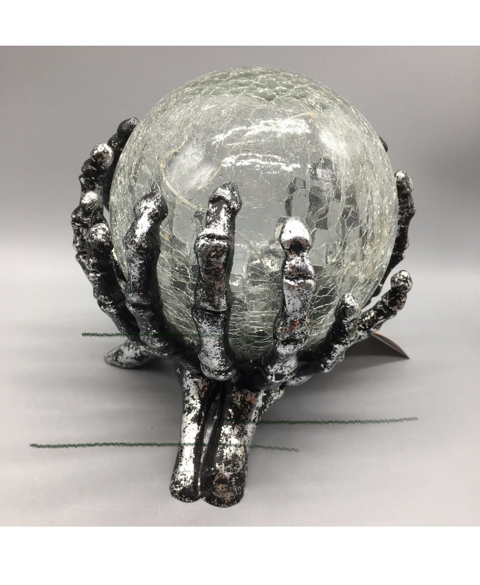 Skeleton Hand Holding Crystal Ball