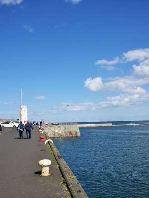 Photo 6x4 Harbour Wall and Lighthouse, Seahouses c2015 | eBay UK