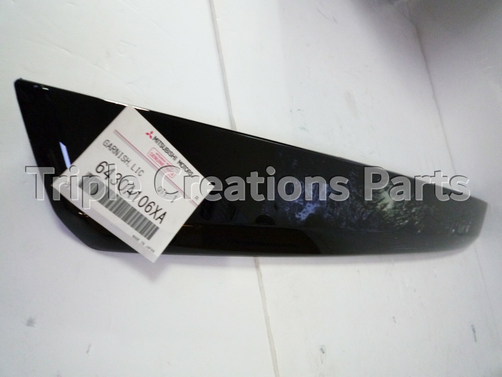 Genuine OEM Mitsubishi 6430A106XA GARNISH,BACK DOOR LICENSE PLATE UPPER ...