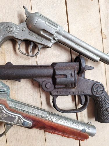 Cap Gun Collection including Cast Iron National, Daisy, Hubley etc ...