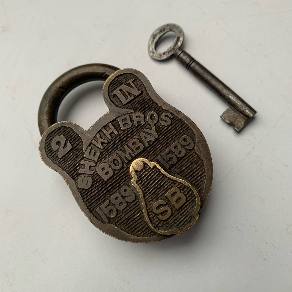 old or antique brass padlock or lock with key nice carving and rich ...
