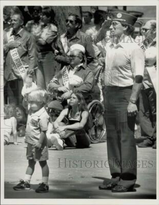 1989 Press Photo Charles Alvanos and Son, Alexander salute during ...
