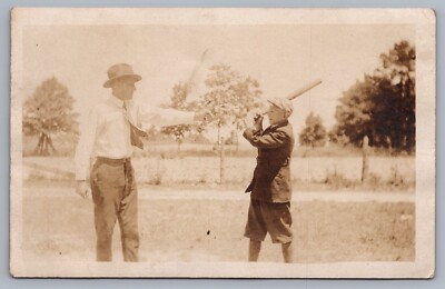 Man Pointing Handgun at Child Weilding Bat Odd Bizzare RPPC Postcard K6 ...