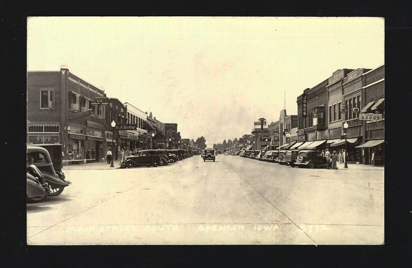 Spencer Iowa IA 1936 RPPC Main St to South, Doudna Drug, Corner Cafe ...