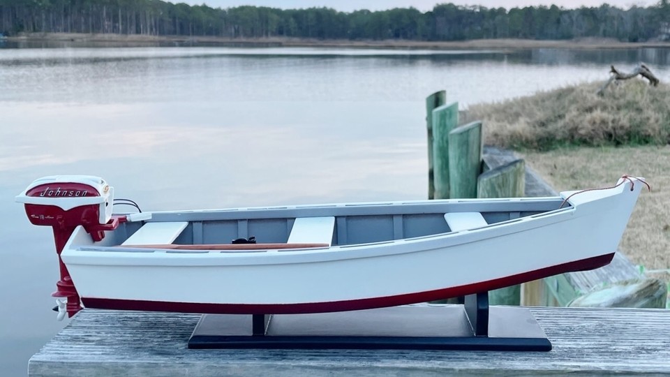 WOODEN SKIFF MODEL, 17.50 INCHES LONG, WITH RED 1957 JOHNSON 18 HP ...