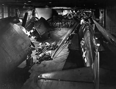 Surrounded by F6F's ordnancemen work bombs hanger deck USS Yorktown ...