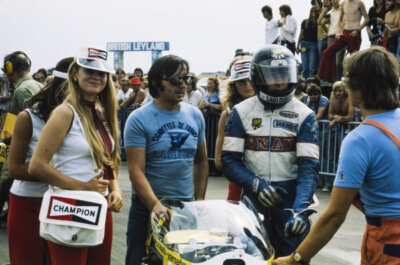 Patrick Pons waits alongside his Yamaha Moto GP Motorcycle Racing 1975 ...