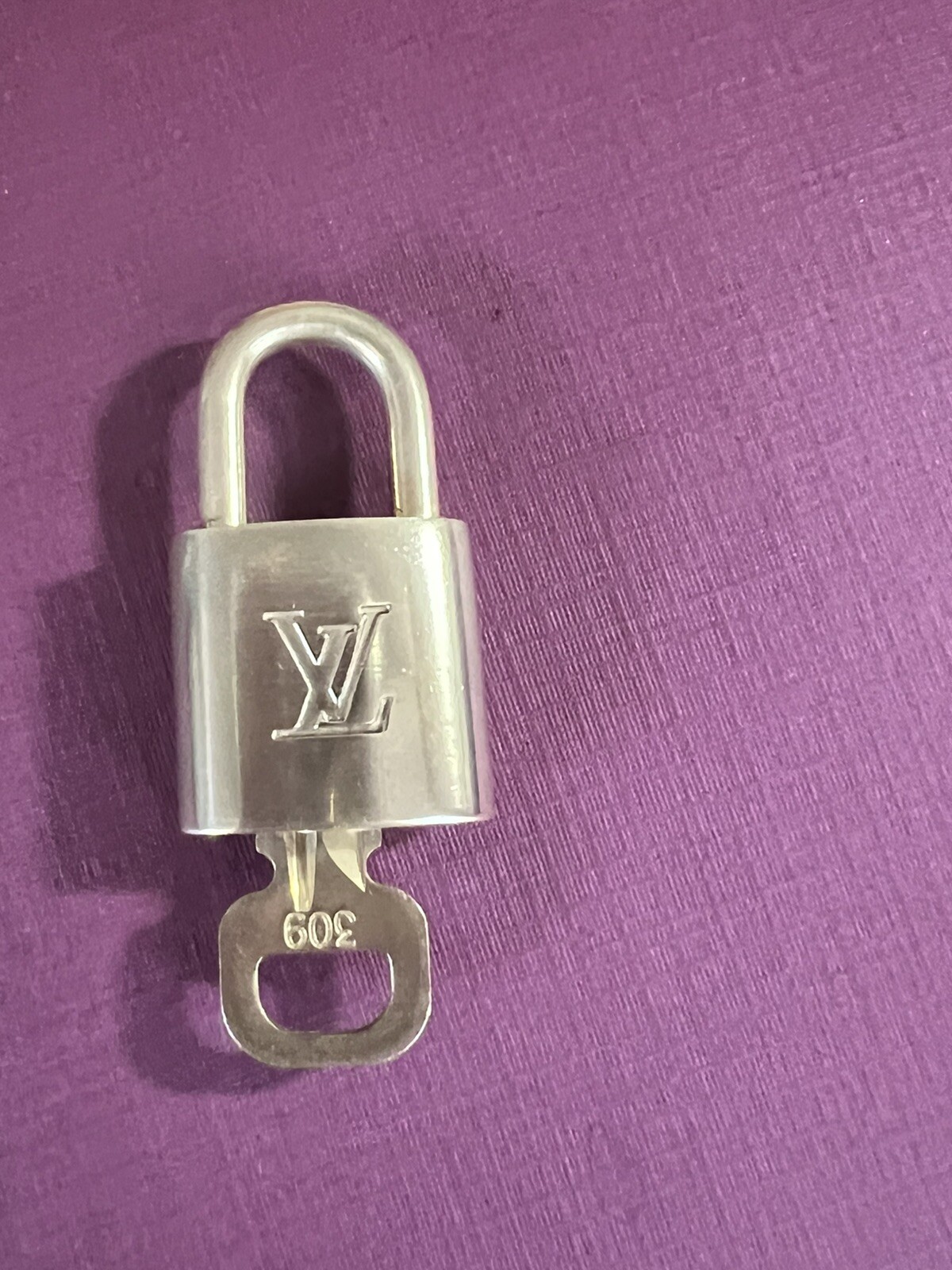 LOUIS VUITTON: Gold/Brass, Metal "LV" Logo Padlock & … - Gem