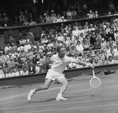 Australian tennis player Rod Laver stoops return a shot during th- 1962 ...