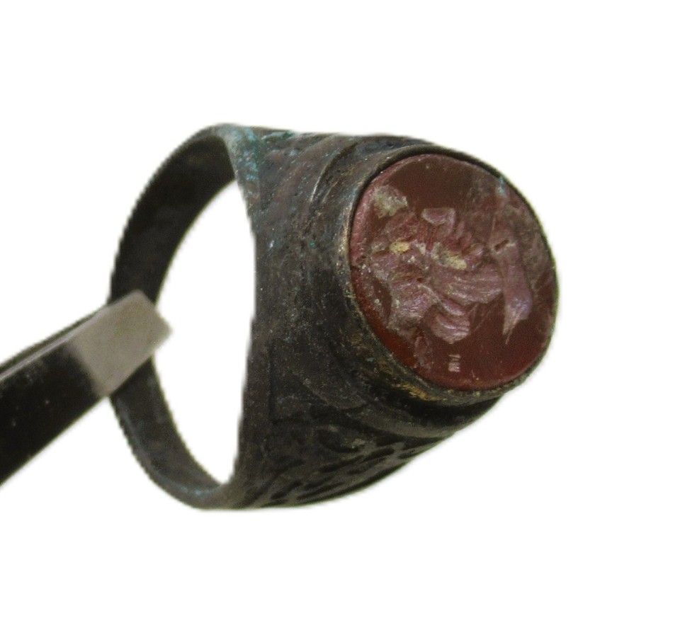 AN ANCIENT ROMAN BRONZE SIGNET RING WITH A RED STONE CRYSTAL INTAGLIO ...