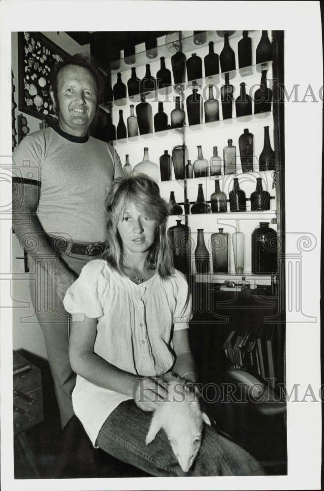 1978 Press Photo Tom & Pat Faris with pet ferret in front of bottle collection | eBay