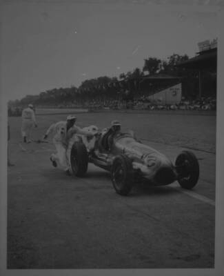 George Connor is pushed onto the track by a mechanic after a ra 1950 ...