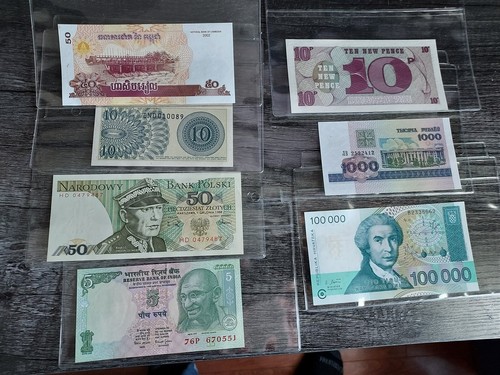 World currency album with 13 uncirculated notes and COA's for all notes ...