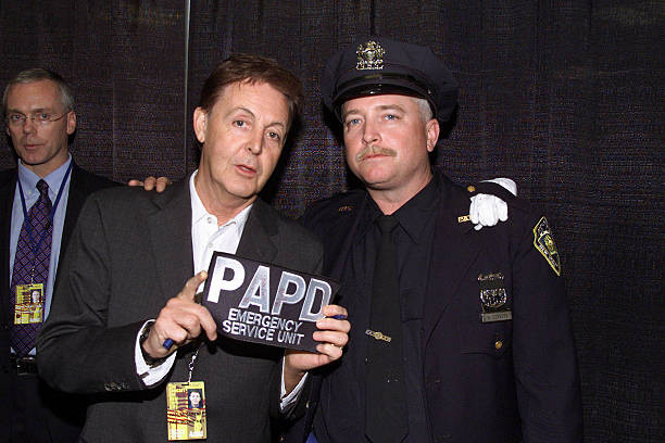 British pop star Paul McCartney with a police officer backstage at- Old ...