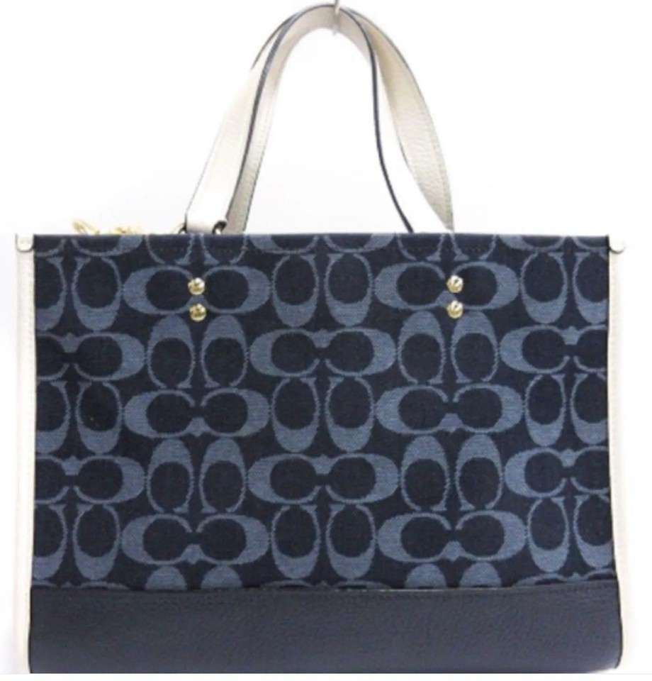 Coach Signature Dempsey Carryall bag (style #C2826) features a ...