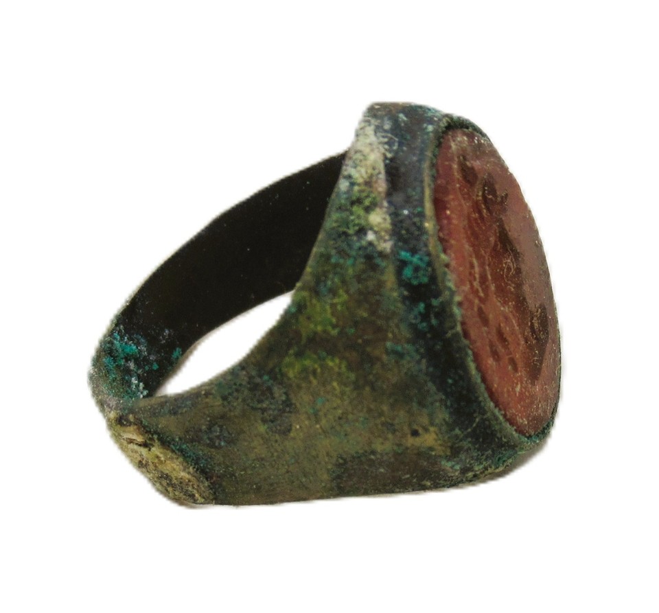 AN ANCIENT ROMAN BRONZE SIGNET RING WITH A RED STONE CRYSTAL INTAGLIO ...