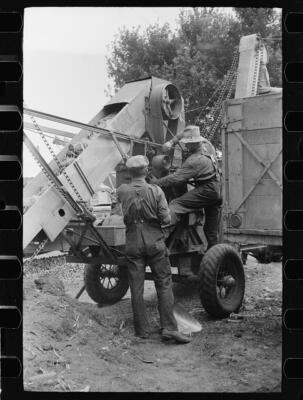 Fixing a corn shelling machine Grundy County Iowa 1930s Historic Old ...
