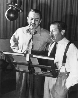 Walt Disney voice Mickey Mouse stands next Clarence Nash who del- Old ...