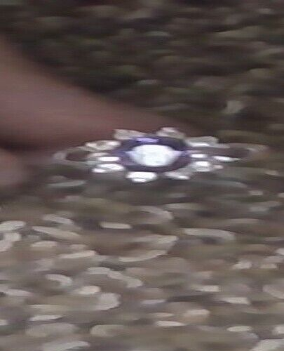 amethyst ring with 8 white gems surrounding it to look like a flower ...
