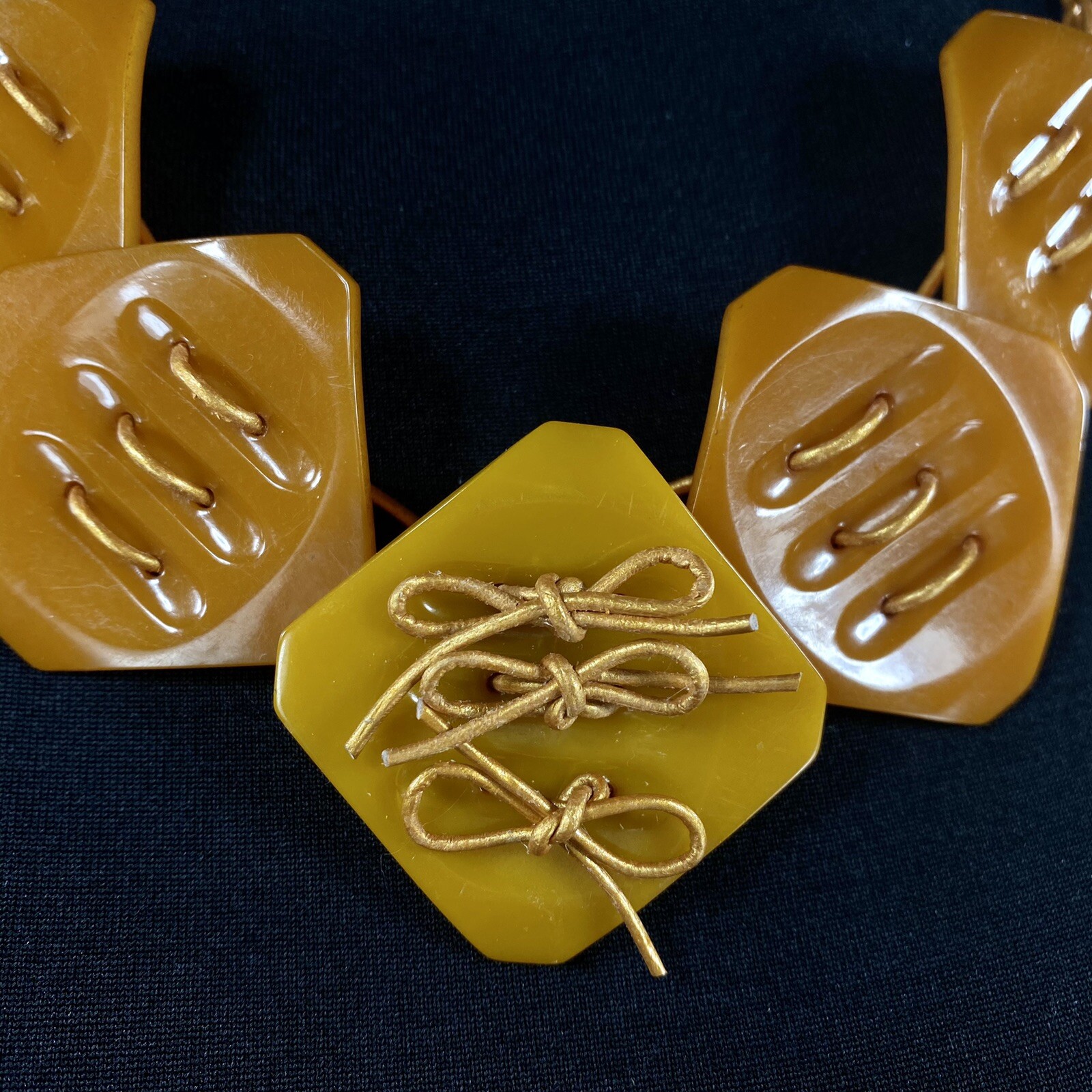 Buttons & Bows, Butterscotch Bakelite Necklace on Metallic Leather Cord ...