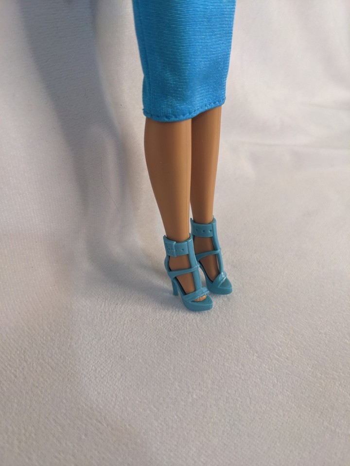 Restyled Barbie Doll wearing pink and blue Barbie looks signature dress ...