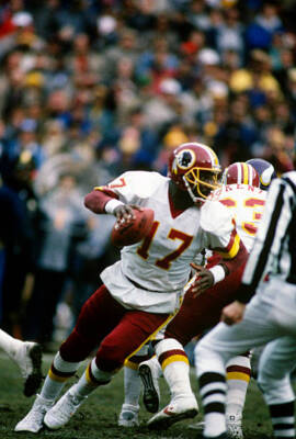 Quarterback Doug Williams Washington Redskins drops back to - Football ...