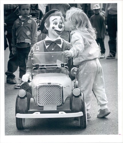 1996 Press Photo Cute Girl Kisses Remote Control Clown in Mini Car ...