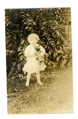 Child holding a tattered toy teddy bear - Vintage RPPC Real Photo ...