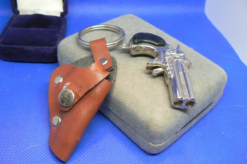 A REALLY COOL HOLSTER AND SILVER METAL GUN KEYCHAIN SHOOTS CAPS? R2 ...