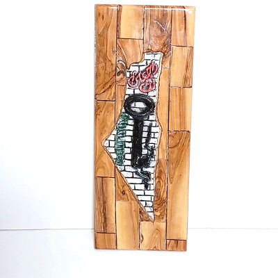 A hand-engraved wooden plaque bearing the map of Palestine and the Key ...