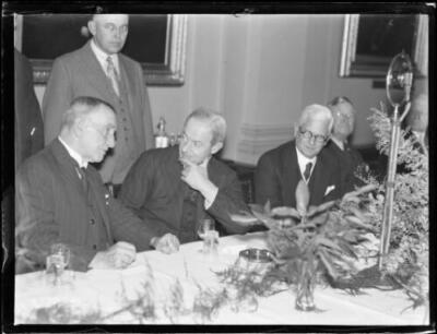 Conductor Sir Hamilton Harty in conversation with two other men, N ...