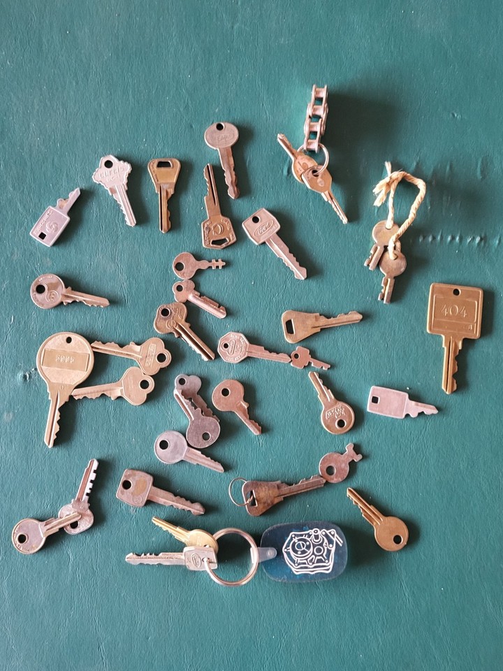 collection of assorted vintage and modern keys with various markings ...