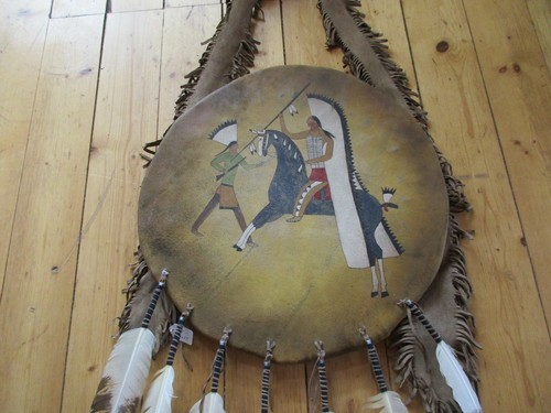 NATIVE AMERICAN CEREMONIAL LEATHER SHIELD, 21" PAINTED "COUNTING COUP ...