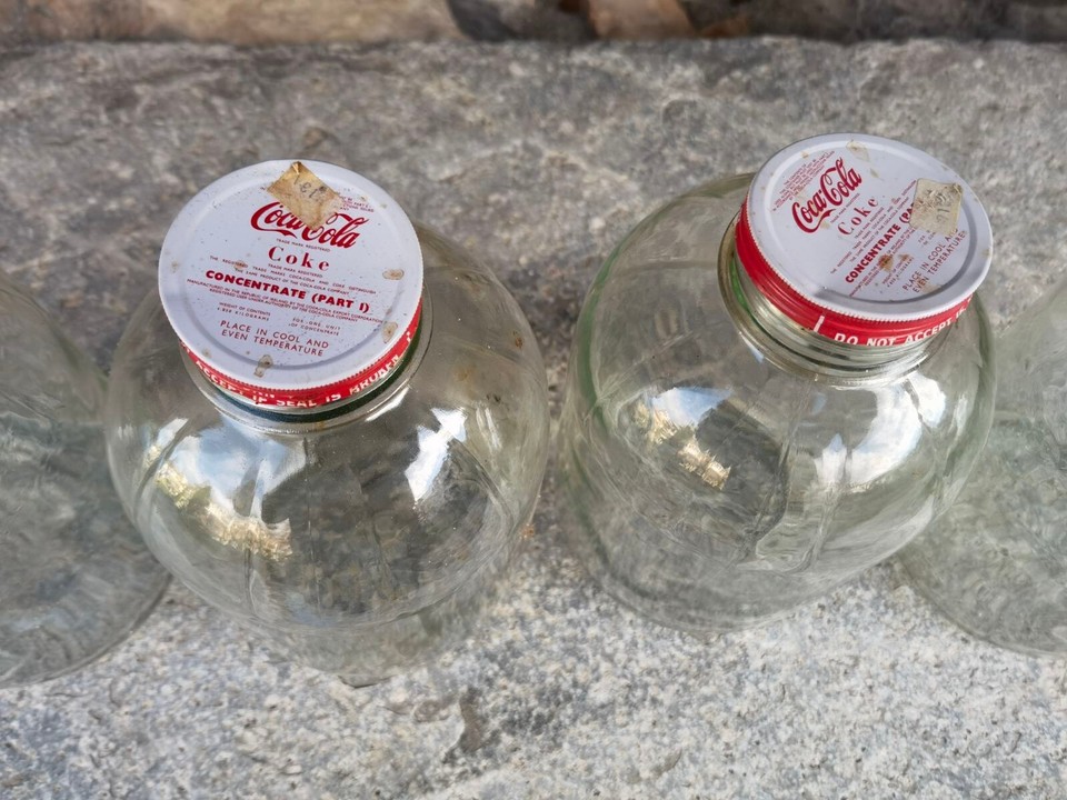 Four large bottles of Coca Cola, collectible Coca Cola concentrate ...