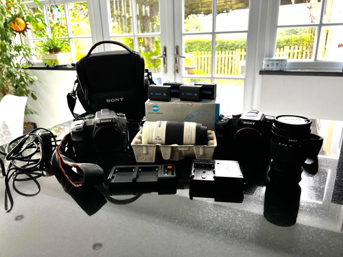 SonY a100 camera + spare body 2 lenses case batteries and charger owned ...