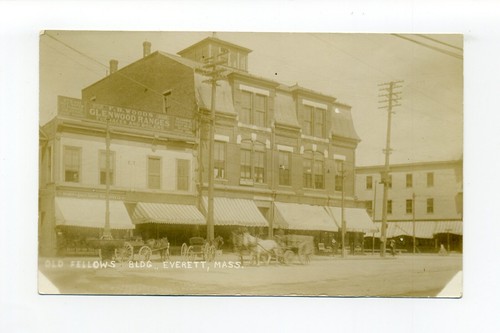 Everett MA RPPC photo postcard, Street View, signs, stores, horses ...