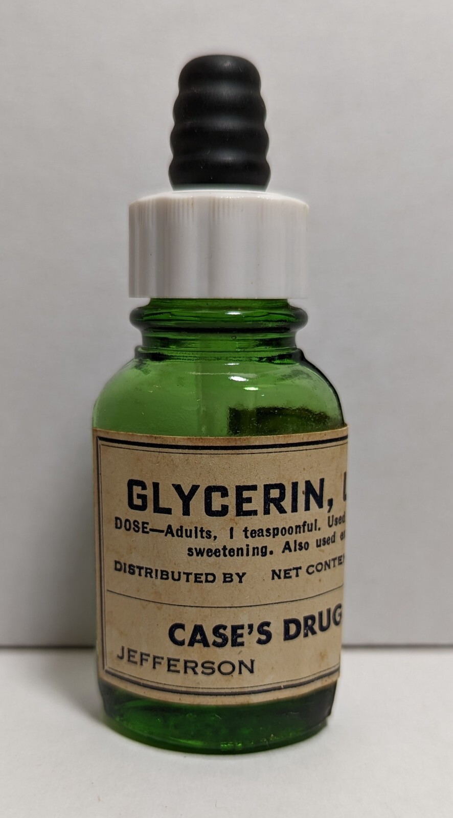 Vintage medicine green bottle with dropper and paper label. Cases Drug ...
