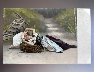 Slovenia • Young Child Hugging Woman Laying on the Ground • Message Tab ...