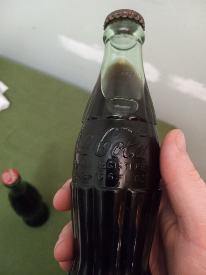 collectable coke bottles total of three , full with original coke etc ...