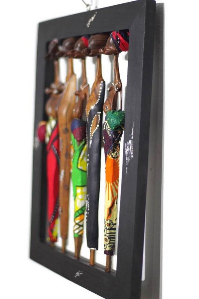 Mozambique Sandal Wood African families on a black painted frame. Wall ...