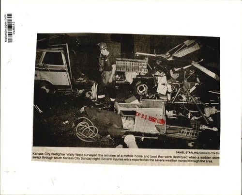 1992 Press Photo Kansas City firefighter Wally West inspects storm ...
