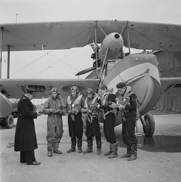 group naval air observers standing front a Supermarine Walrus amph ...